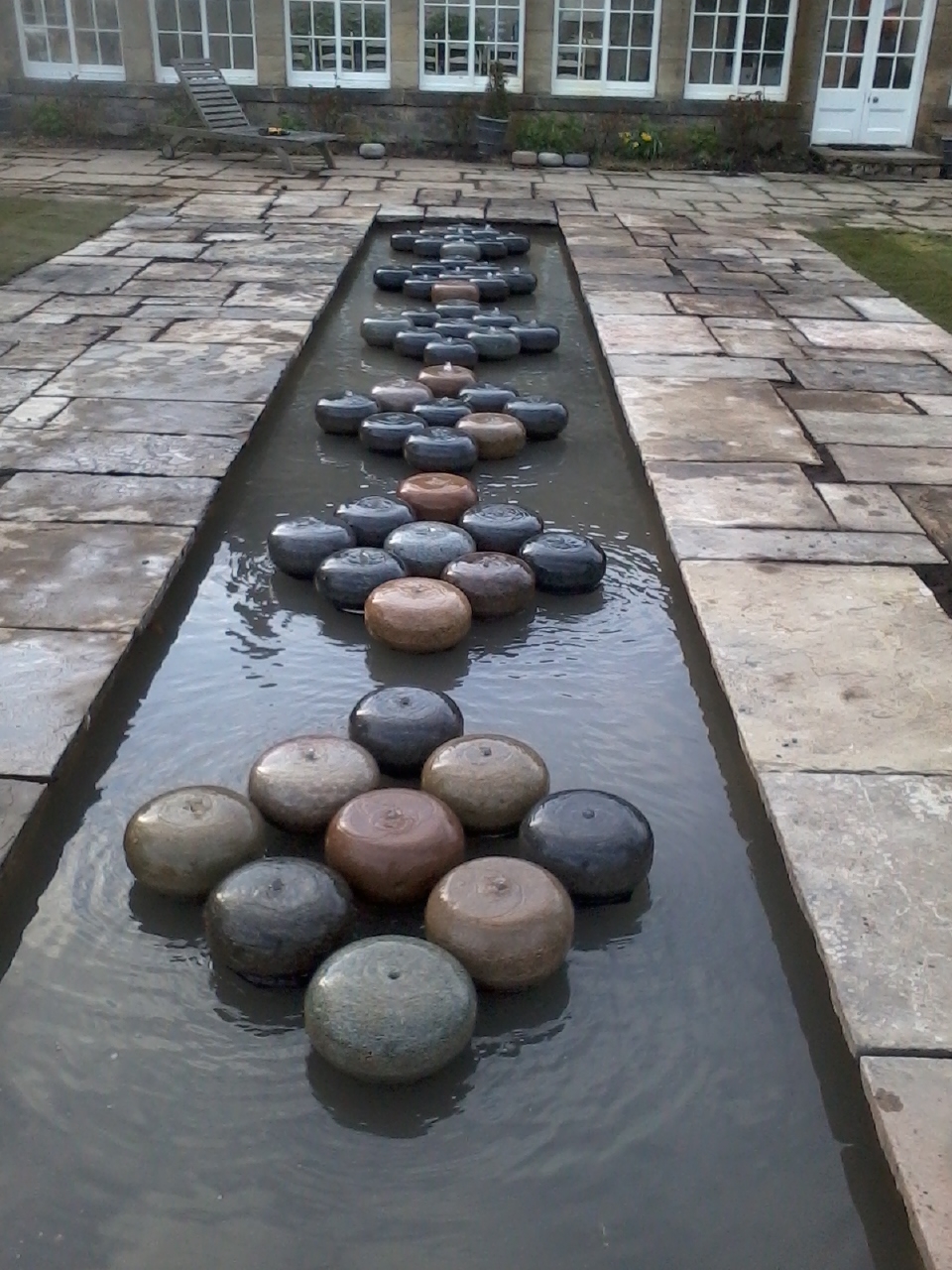 Curling stones on a reflective pond - Almond Landscapes