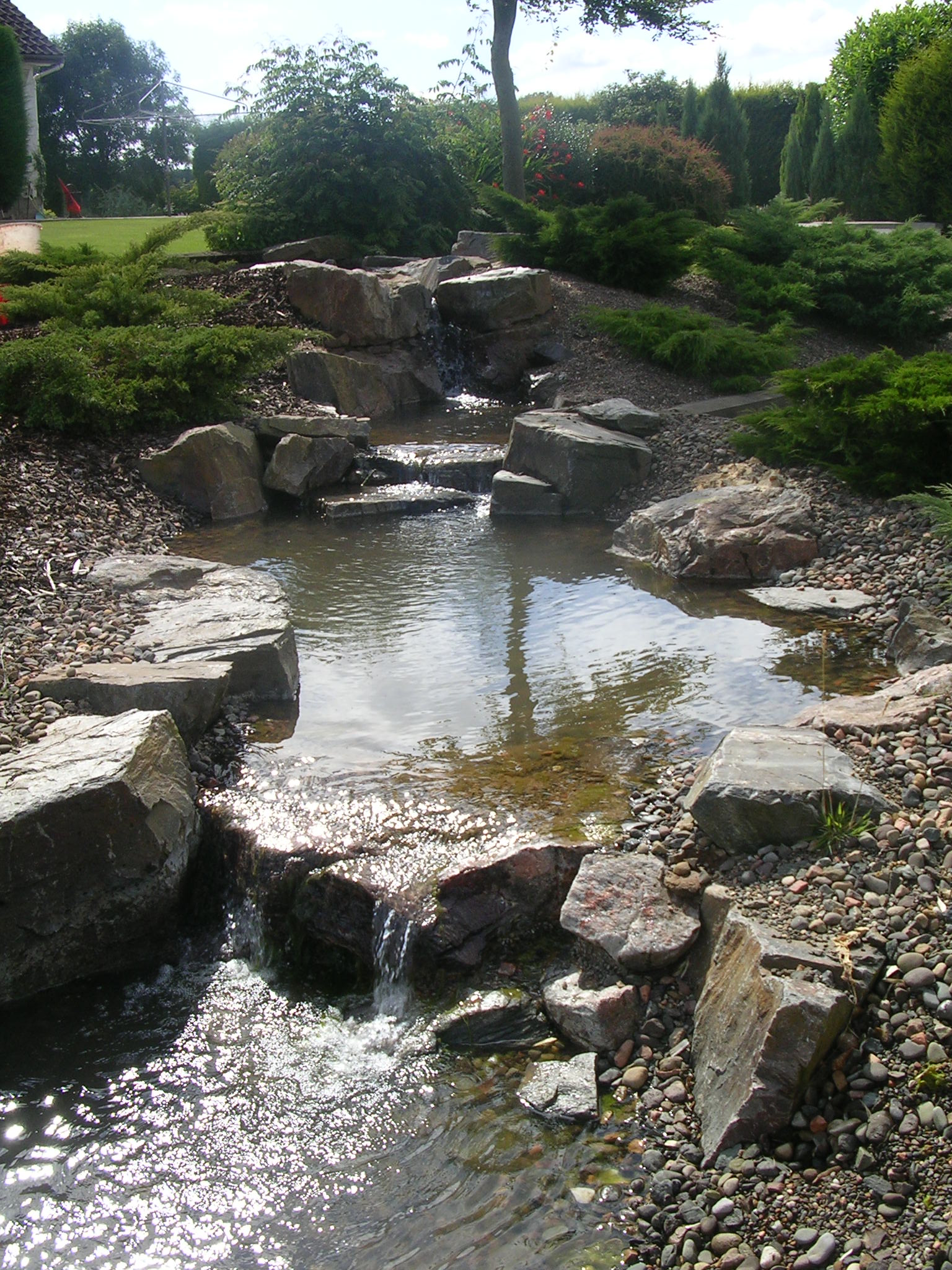 Large stream with granite rock - Almond Landscapes
